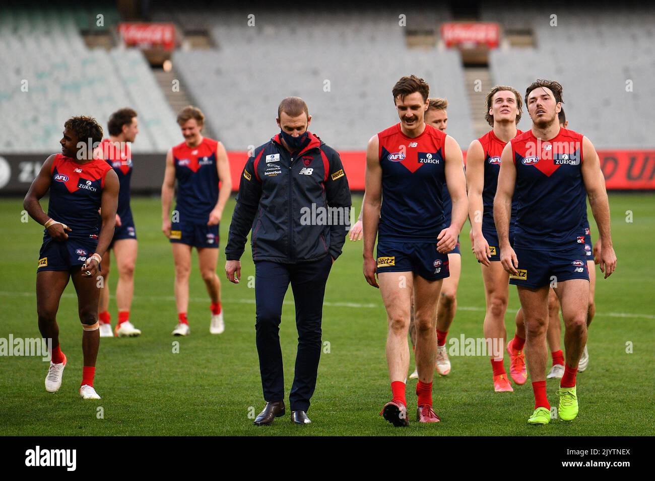 Melbourne Demons head coach Simon Goodwin (centre) exits the field with ...