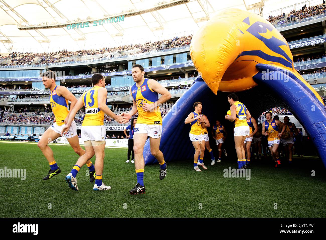 Eagles players enter the field before the start of play during the AFL ...