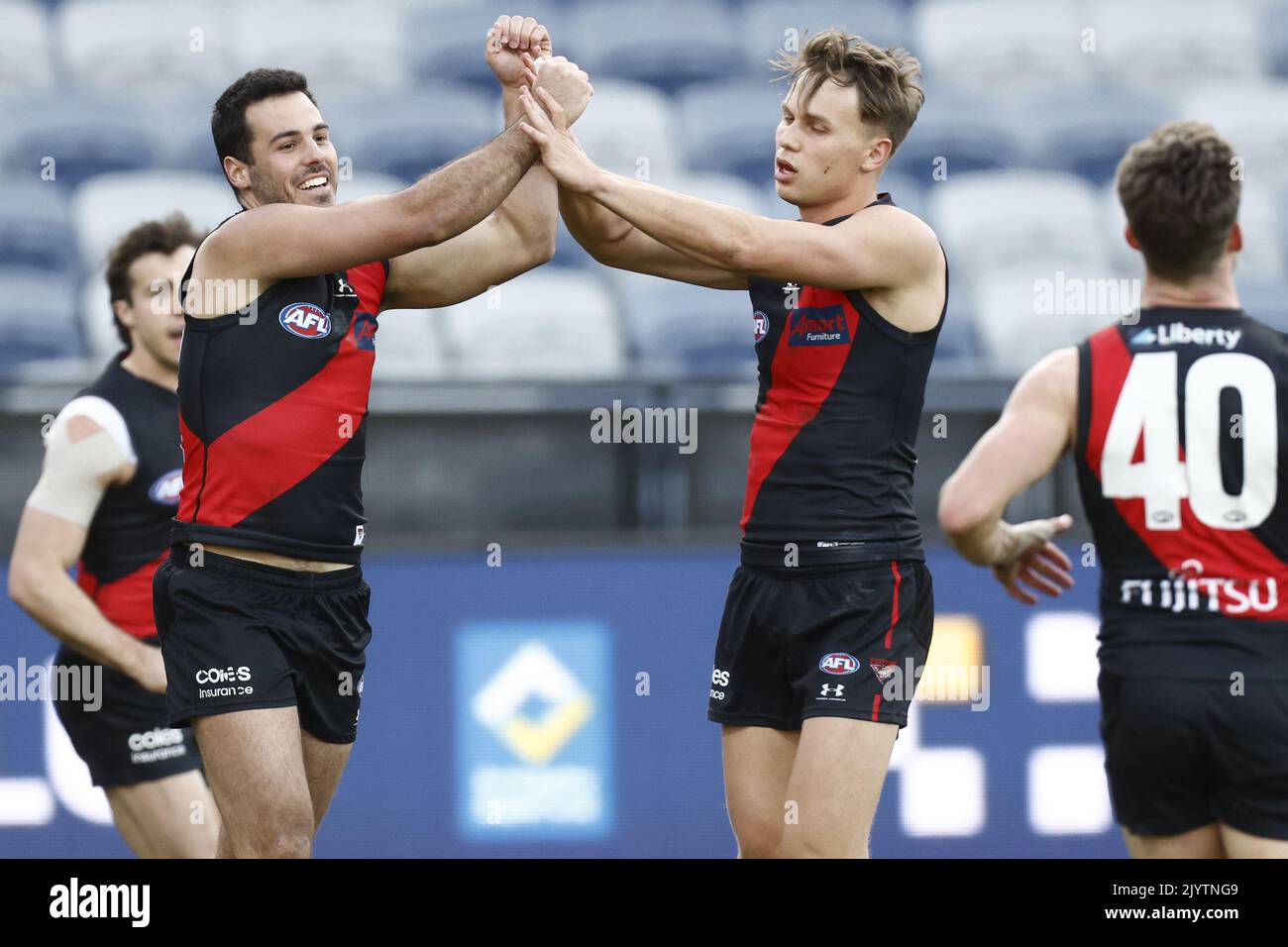 Alec Waterman of the Bombers (left) celebrates a goal during the AFL ...