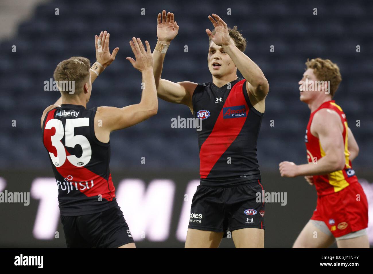 Dylan Clarke of the Bombers (centre) celebrates a goal during the AFL ...