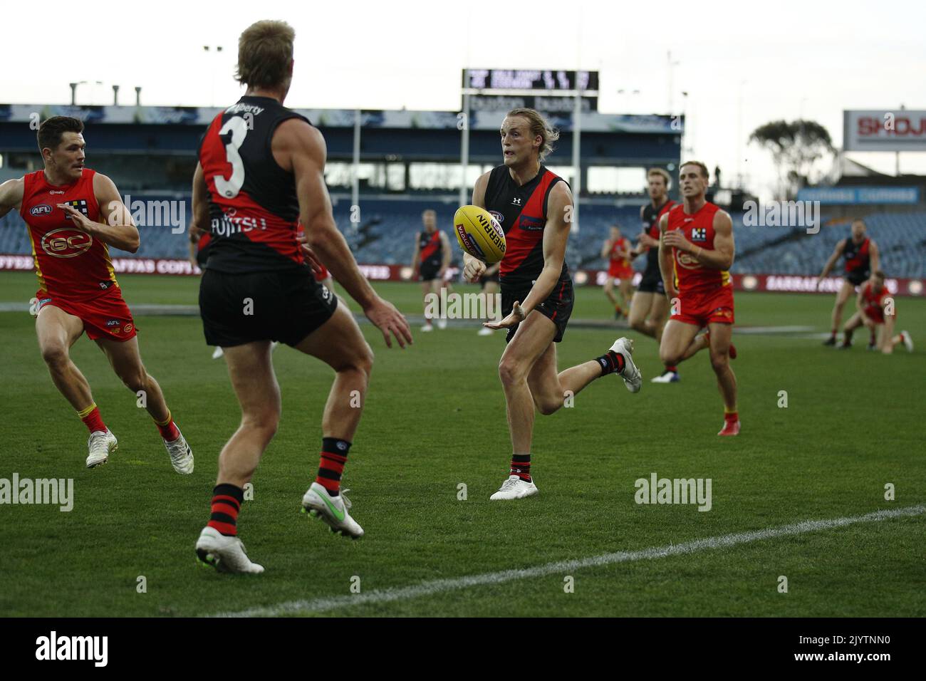 Mason Redman of the Bombers handballs during the AFL Round 22 match ...