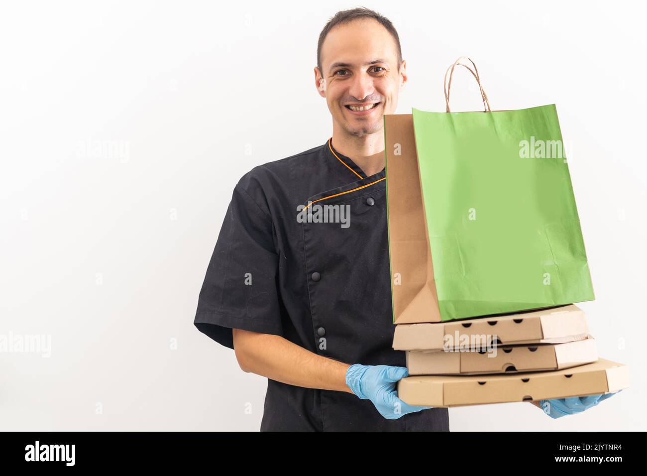 Delivery man with boxes of pizza, chef Stock Photo - Alamy