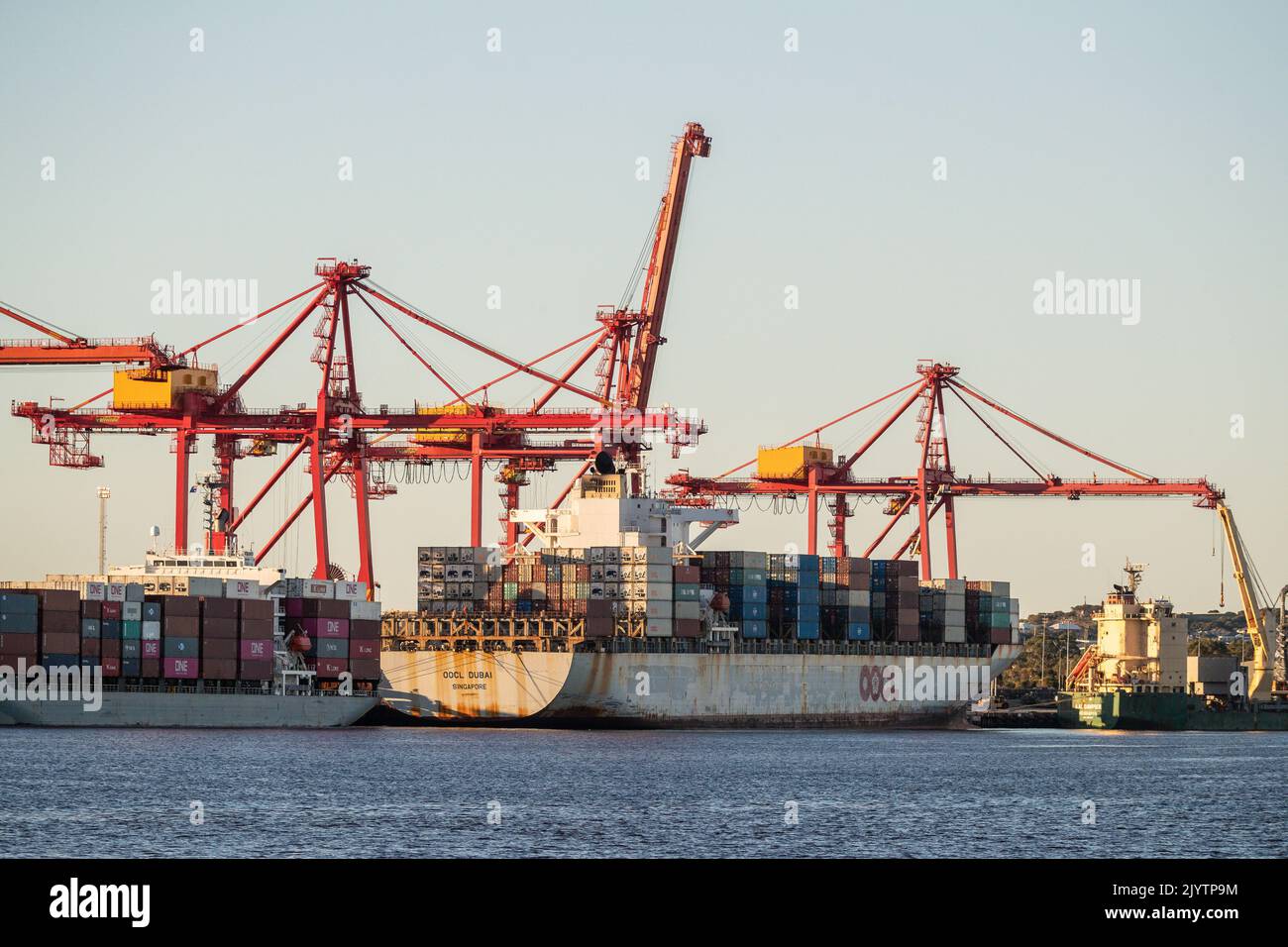 Shipping containers are seen being loaded onto container ships at ...