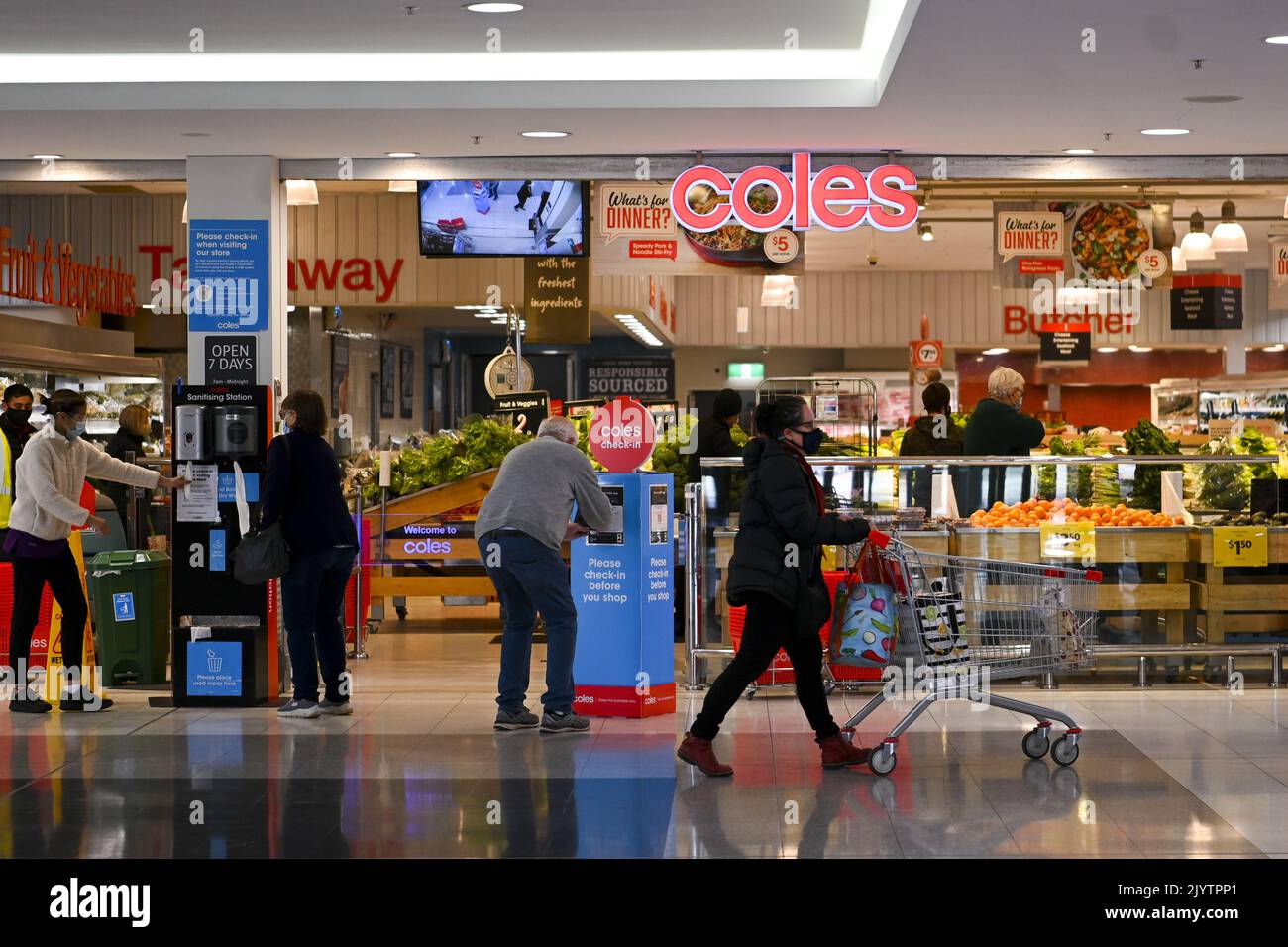 Shoppers walk past at a Coles supermarket in Canberra, Wednesday ...