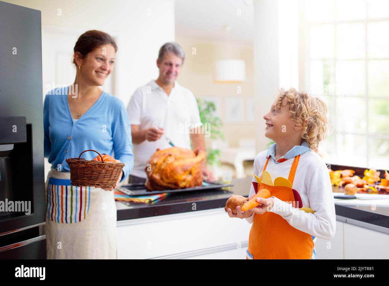Turkey for Thanksgiving. Family cooking festive dinner. Mother, father ...