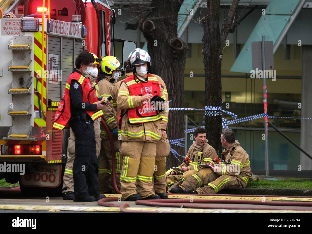 Firefighters work at the scene of a car fire in Melbourne, Friday ...