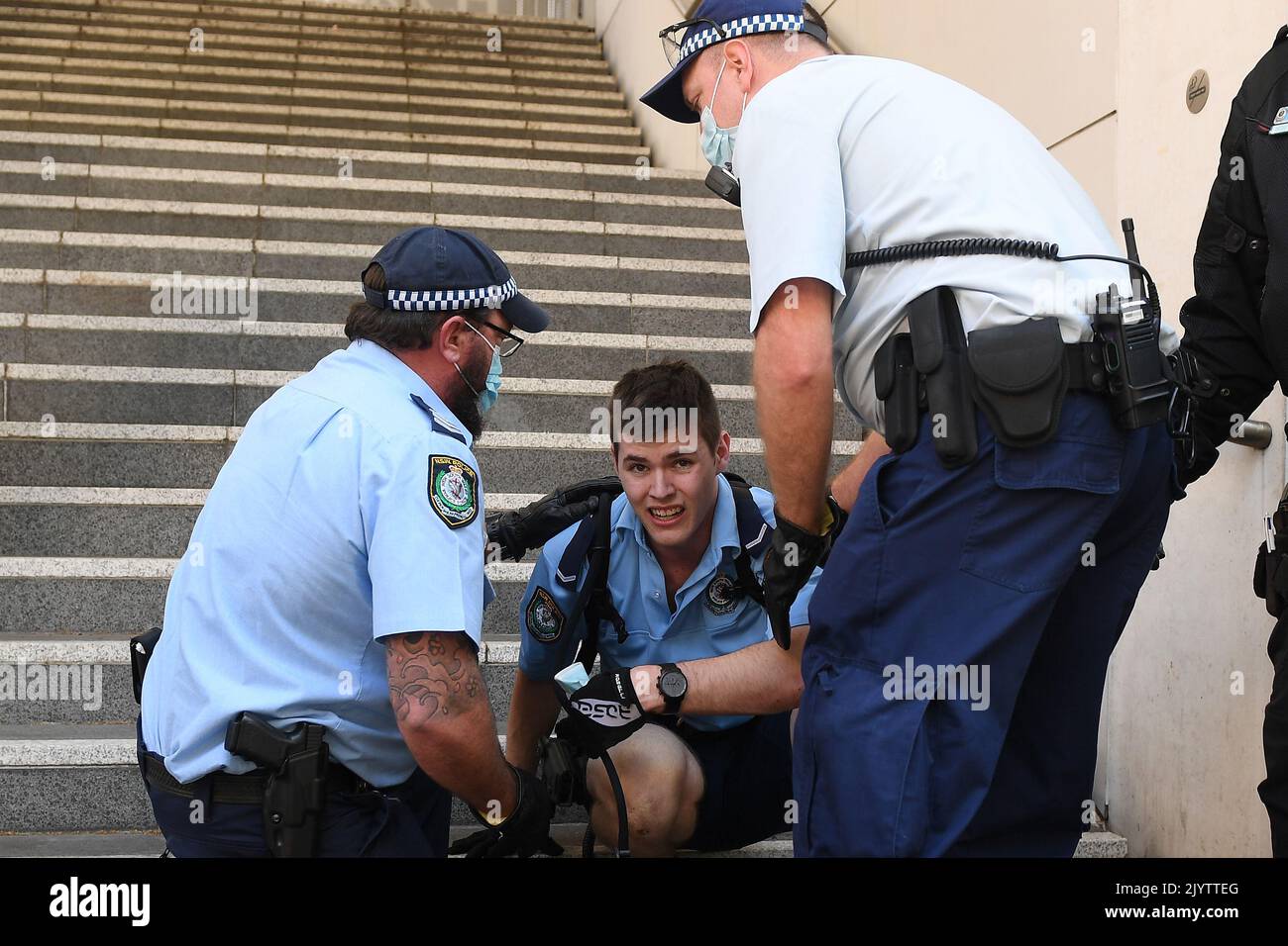 An injured Police officer is assisted during an anti-lockdown protest ...