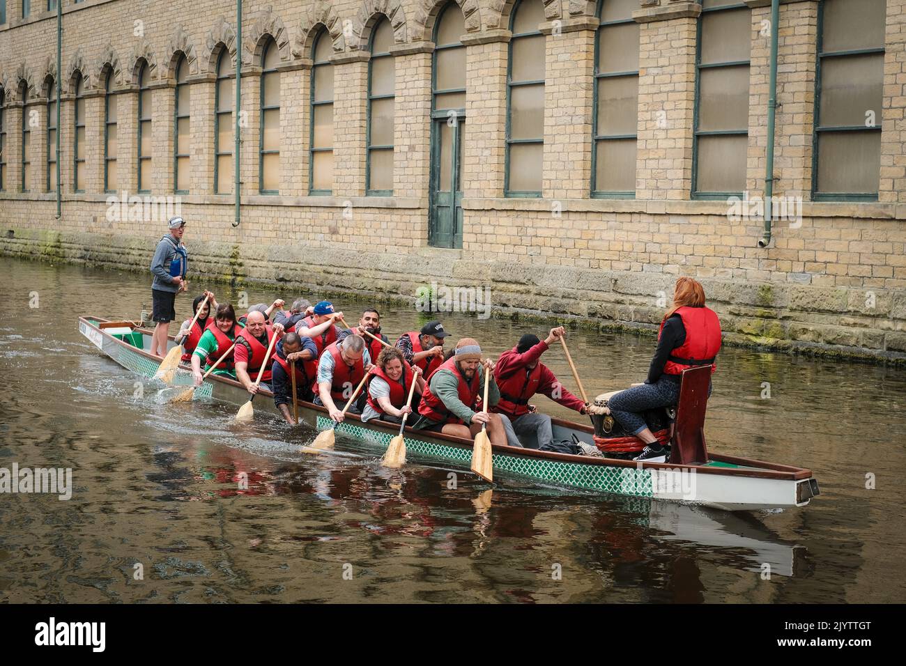 Dragon Boat on the canal at Saltaire, West Yorkshire, UK Stock Photo ...