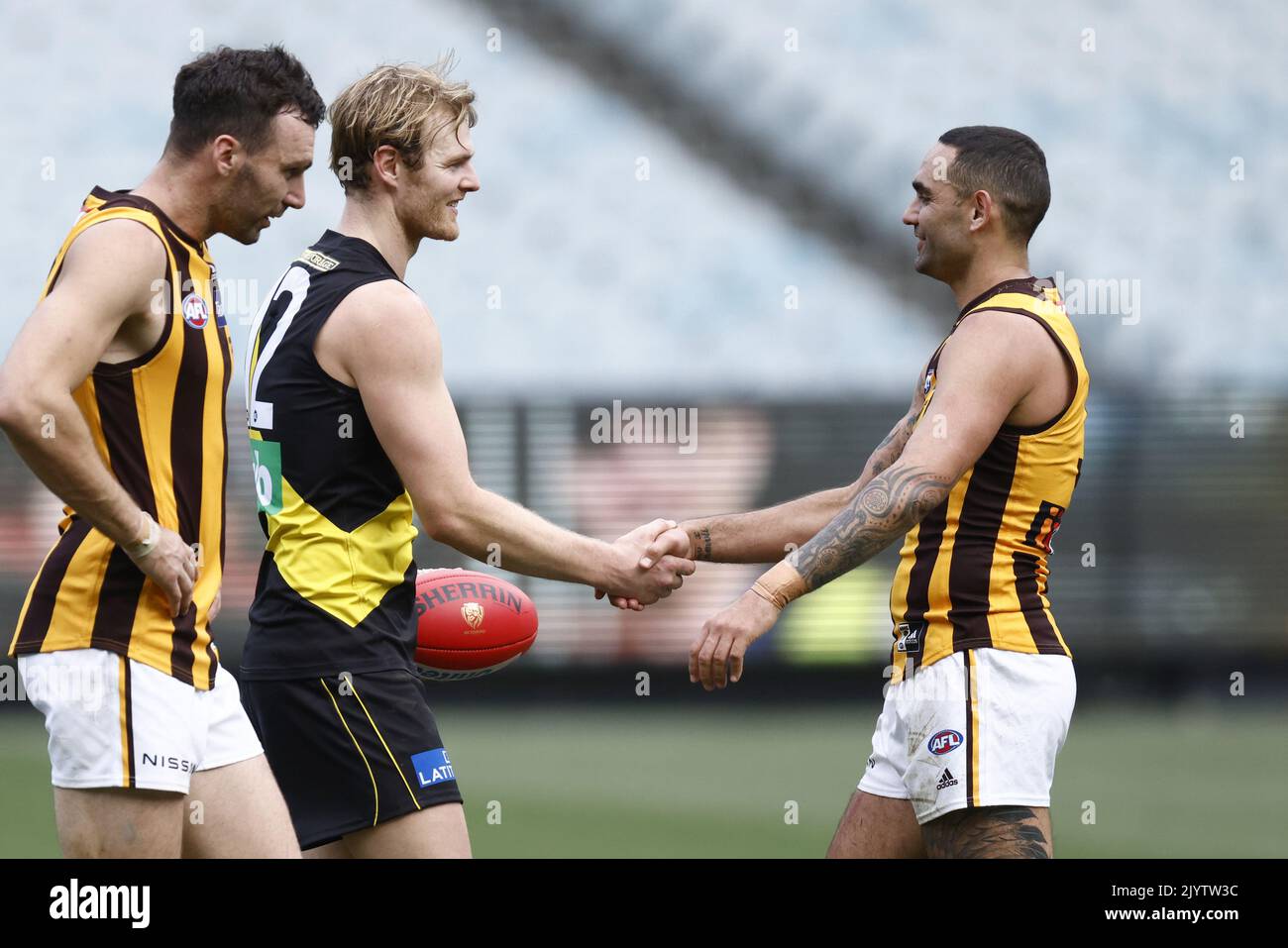 Shaun Burgoyne of the Hawks shakes hands with David Astbury of the ...