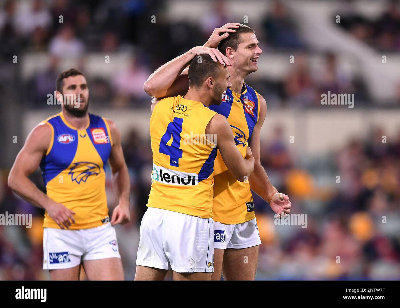 Nathan Vardy of the Lions (right) celebrates after kicking a goal ...