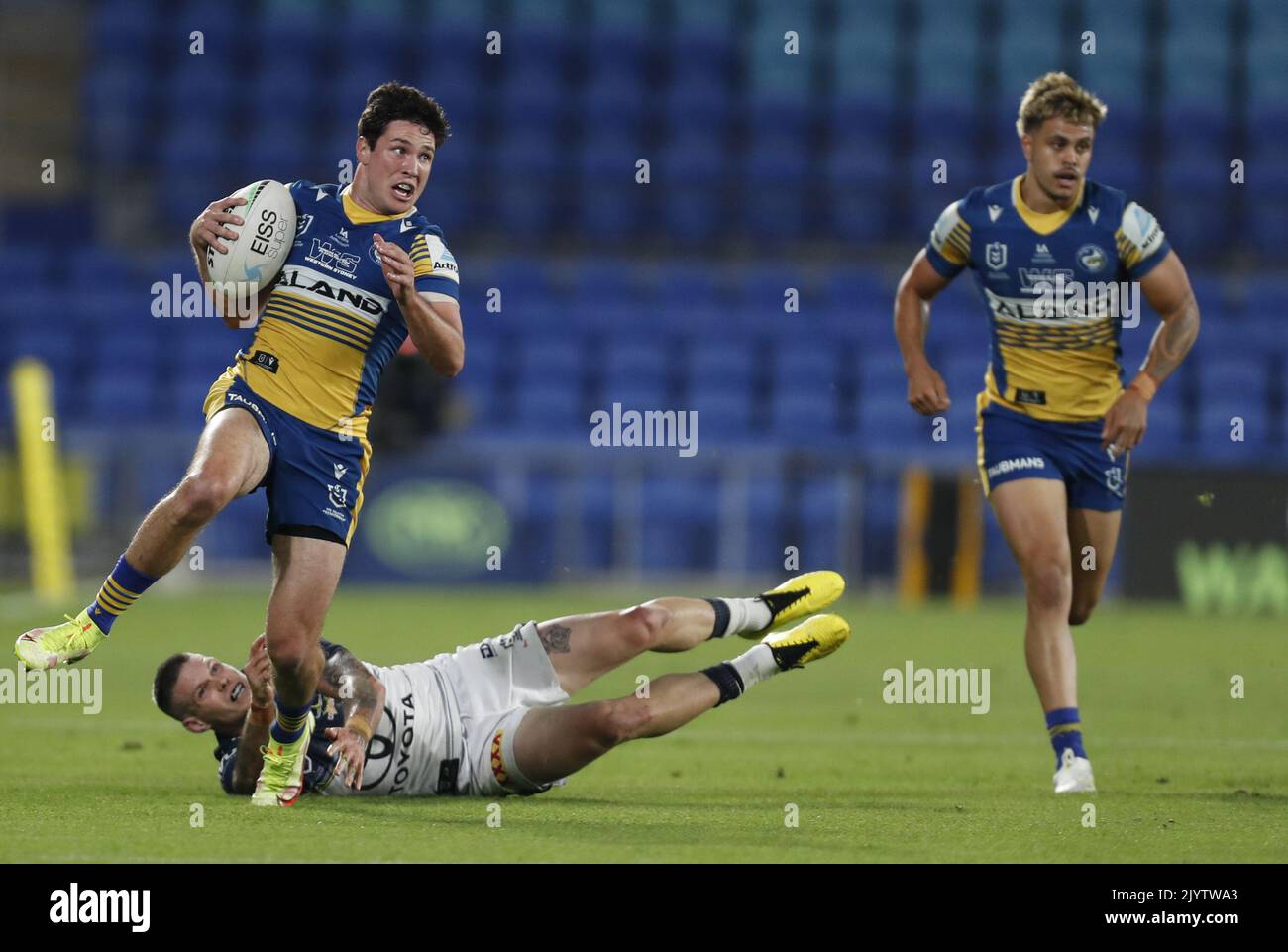 Mitchell Moses of Parramatta Eels escapes a tackle by Ben Hampton of ...