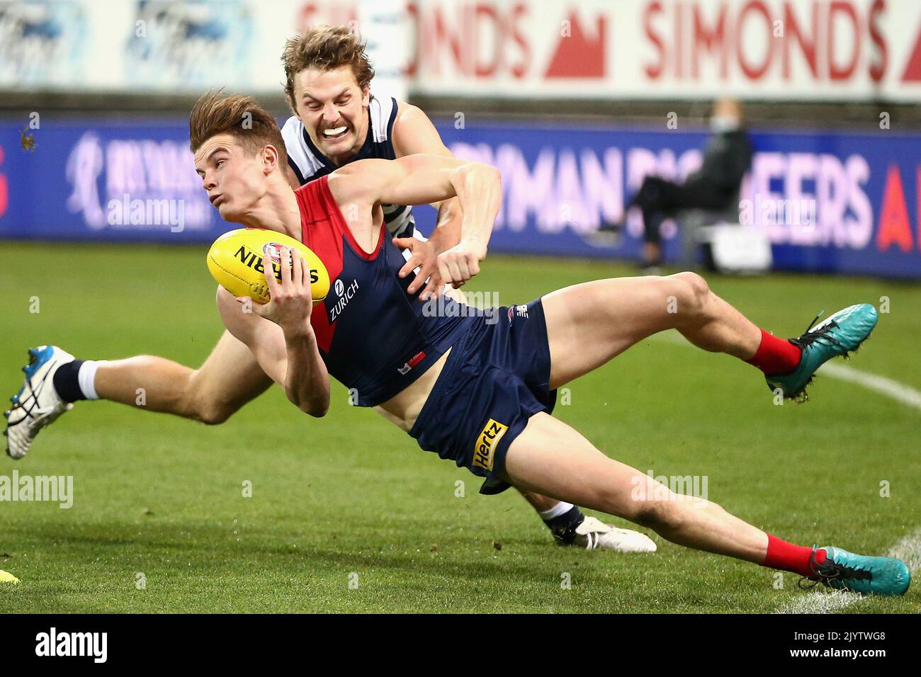 Bayley Fritsch of the demons is tackled during the AFL Round 23 between ...