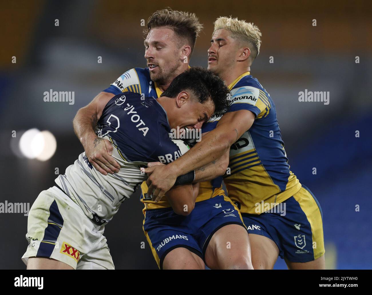 Daejarn Asi (left) of North Queensland Cowboys is tackled by Bryce ...