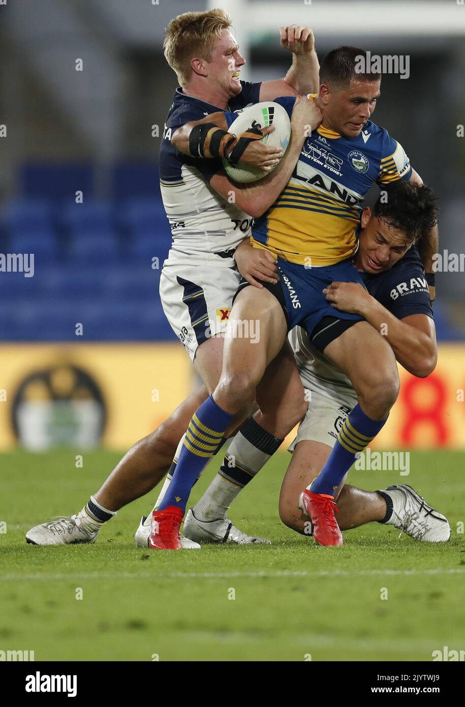 Tom Dearden (left) and Daejarn Asi of North Queensland Cowboys tackle ...