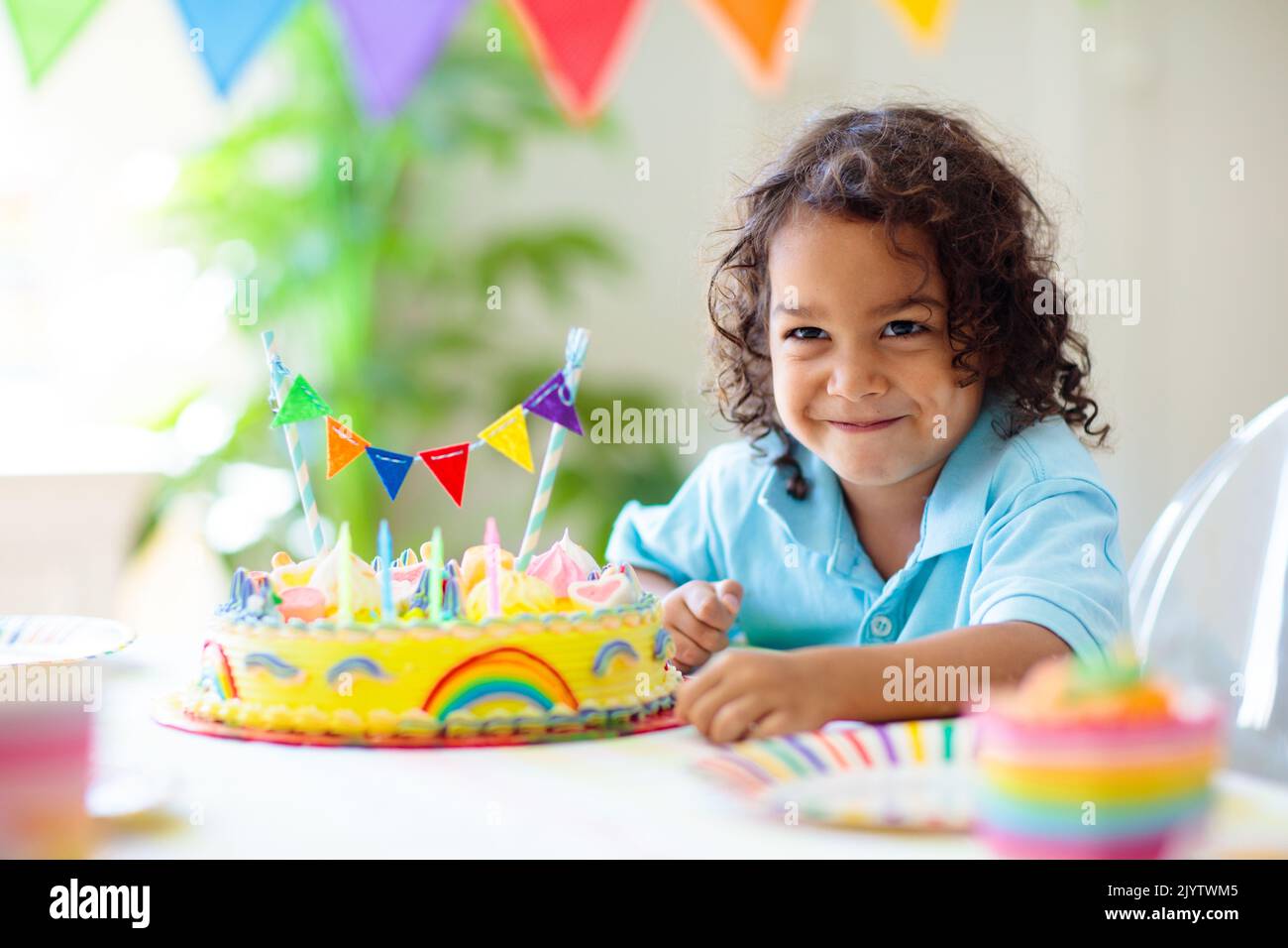 Kids birthday party. Children celebrate with colorful cake and gifts ...