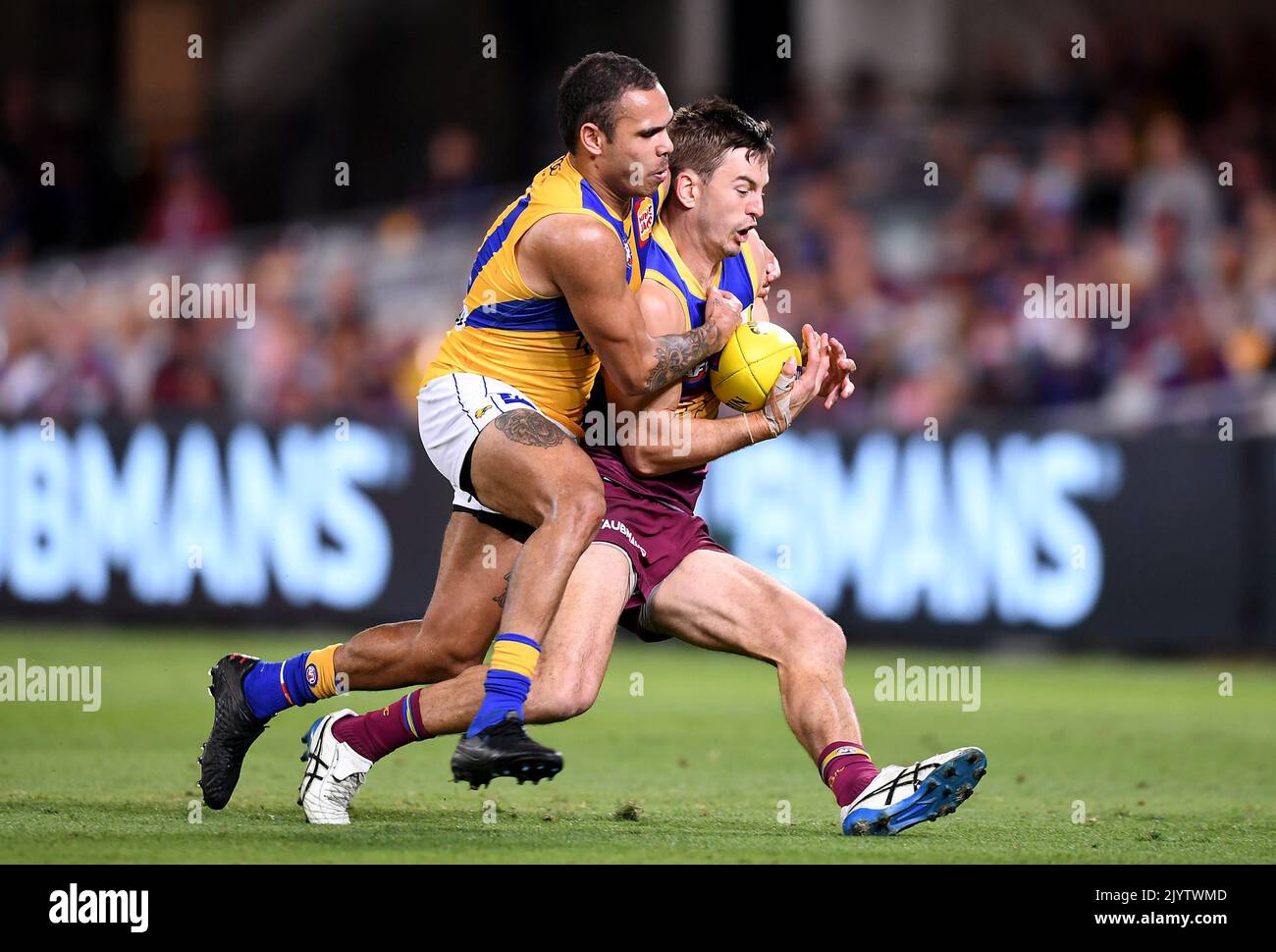 Jamaine Jones of the Eagles tackles Jarryd Lyons of the Lions during ...