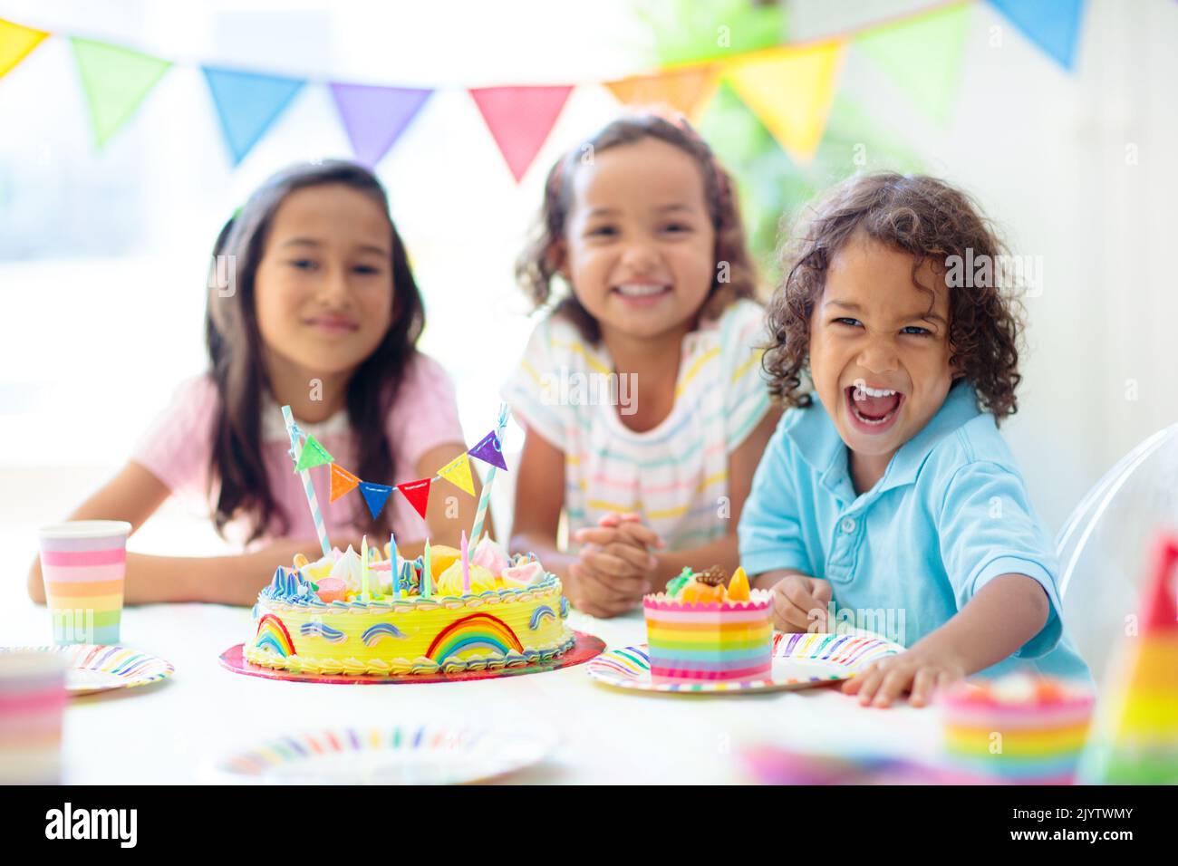 Kids birthday party. Children celebrate with colorful cake and gifts ...
