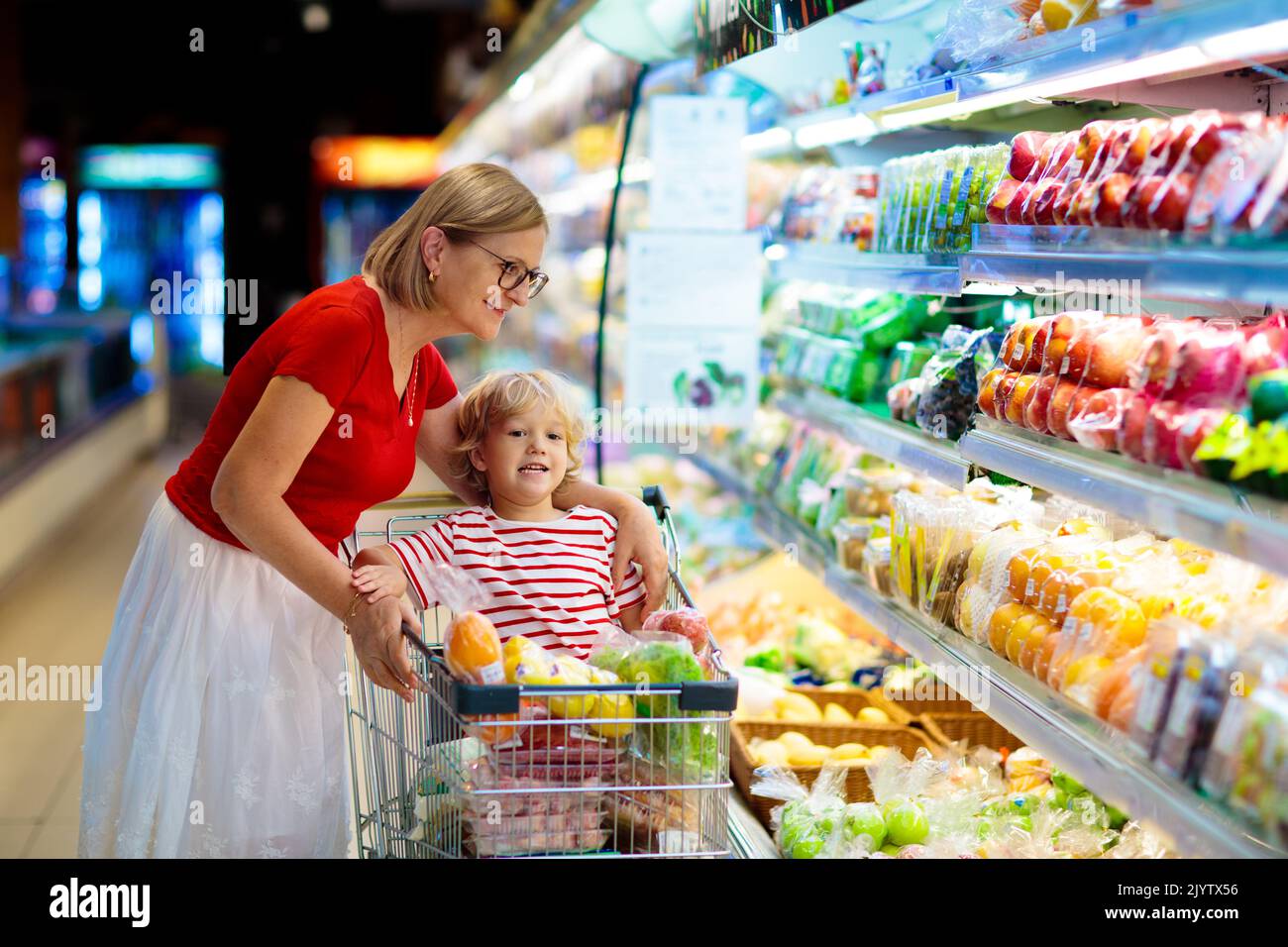 Shopping with kids. Mother and child buying fruit in supermarket. Mom ...
