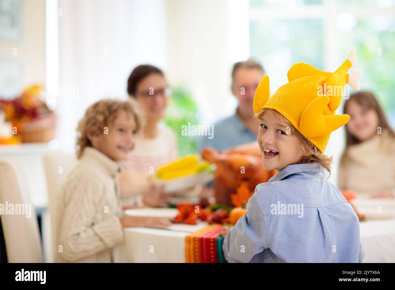 Family at Thanksgiving dinner. Parents and kids enjoy roasted turkey ...