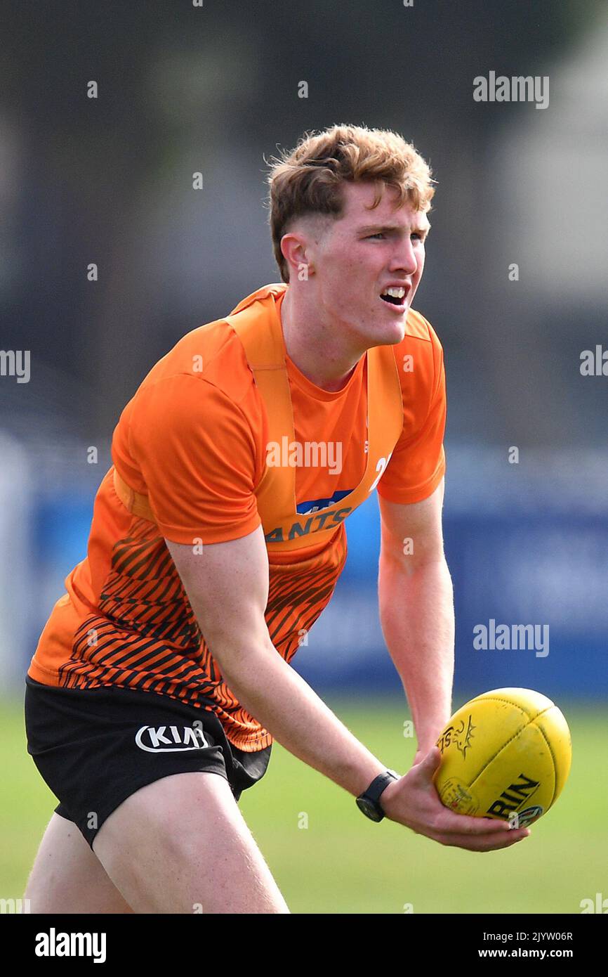 Lachlan Keeffe of the Giants handballs the footy during a GWS Giants ...