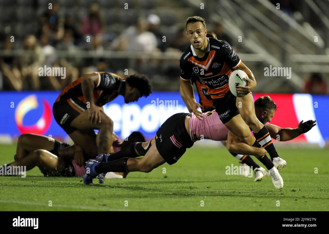 Luke Brooks of Wests Tiger is tackled by Kurt Capewell of Penrith ...