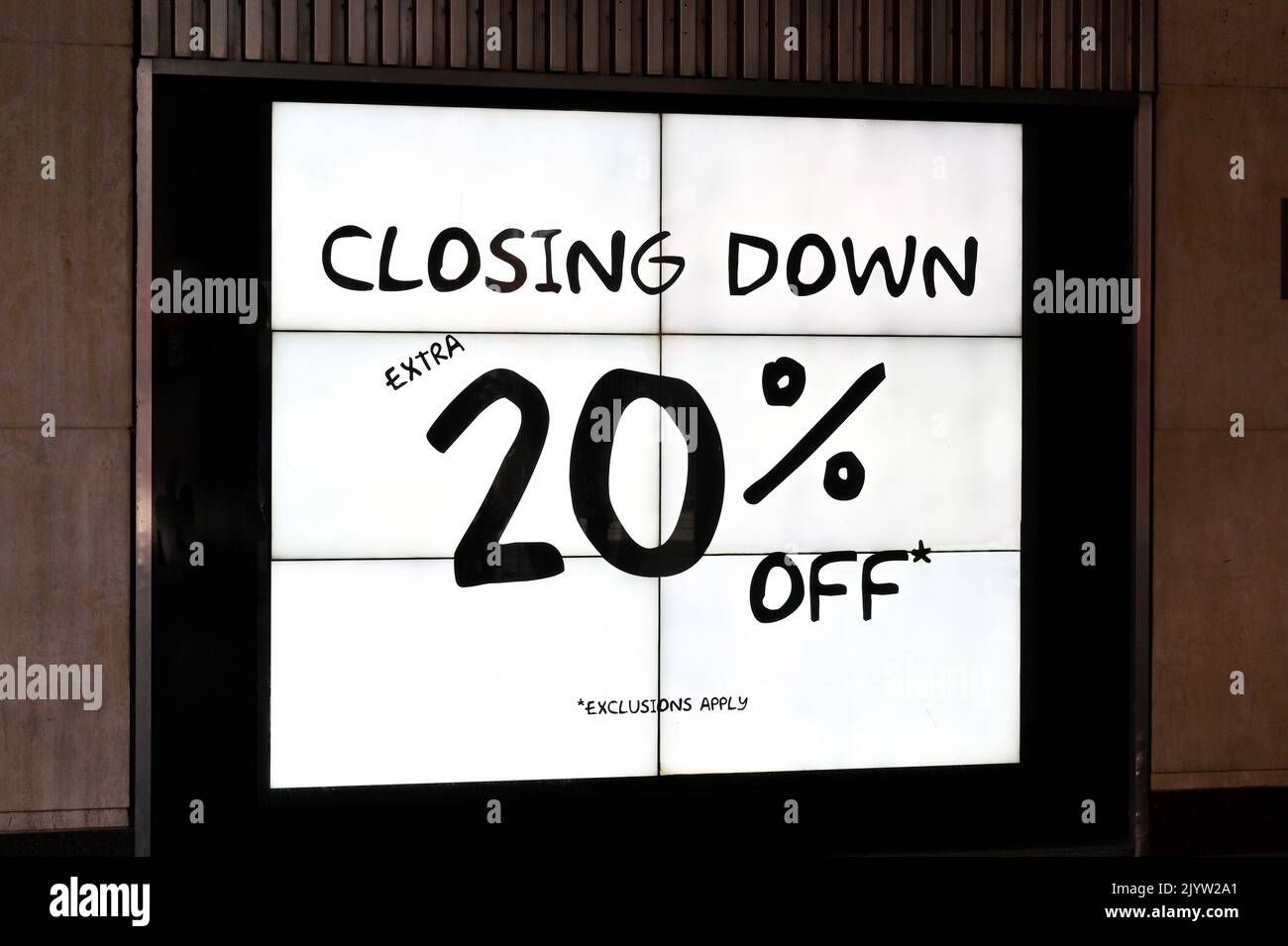 Illuminated sign outside a retail store adverrtising a closing down ...