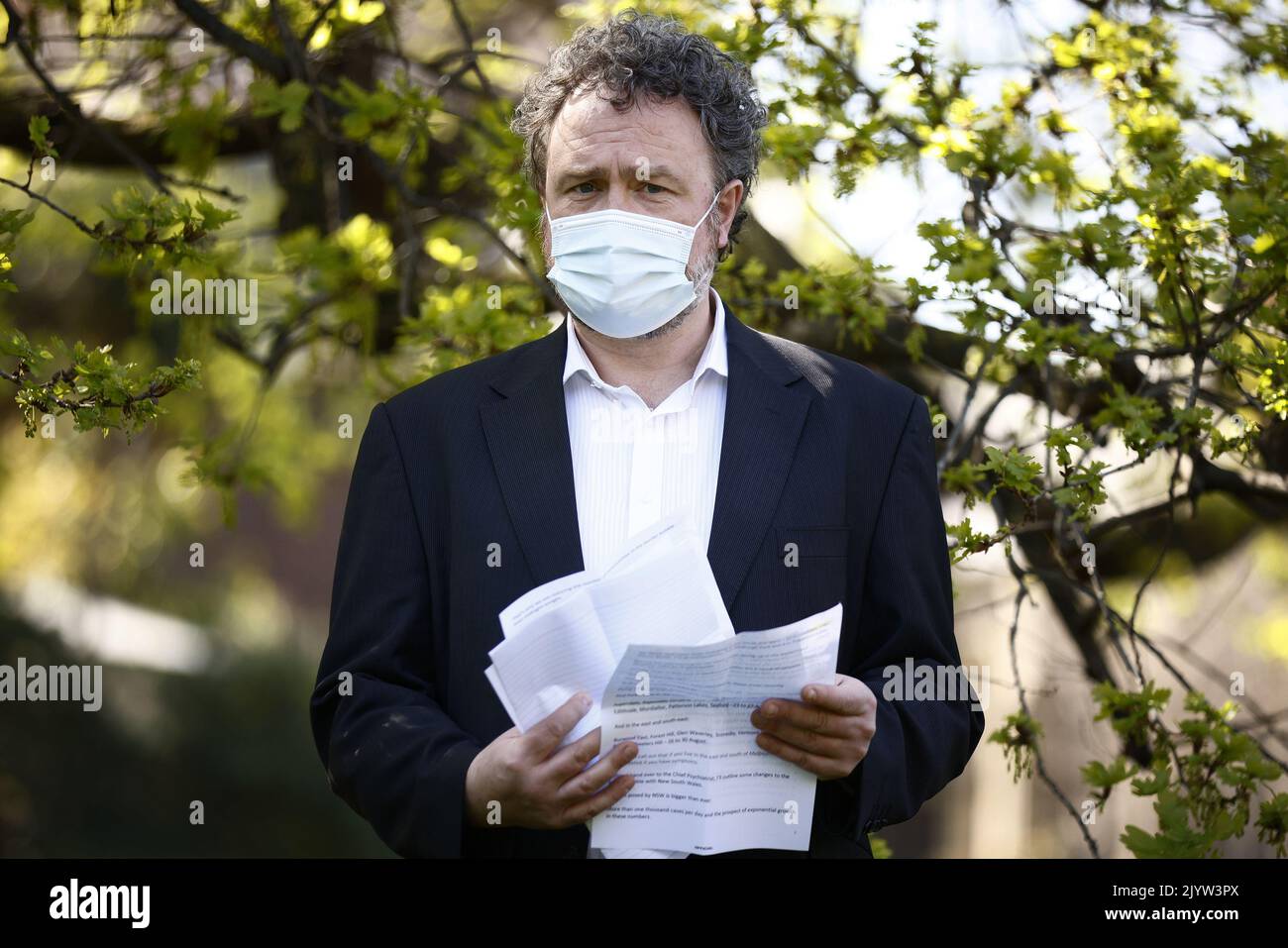 Acting Victoria Chief Health Officer Professor Ben Cowie looks on ...