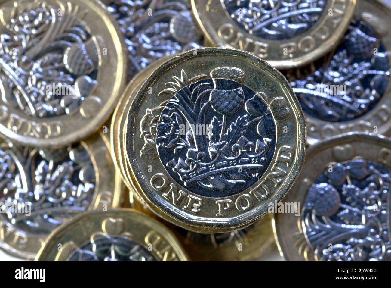 British one pound coin surrounded by other coins. No people Stock Photo ...
