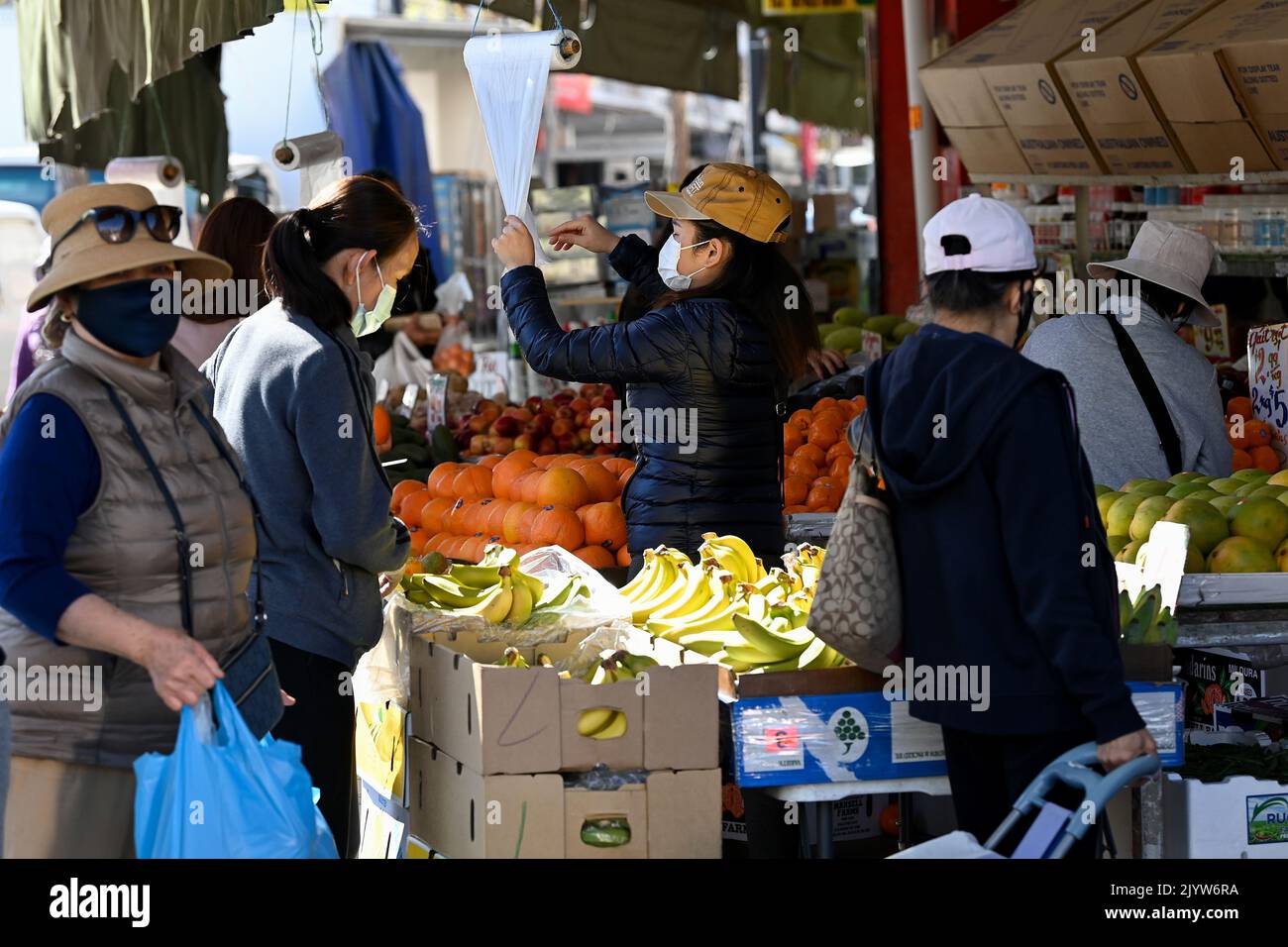 Members of the public wear face masks as they go about their daily ...