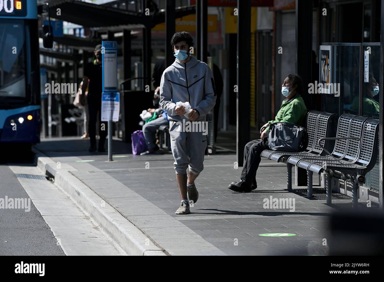 Members of the public wear face masks as they go about their daily ...