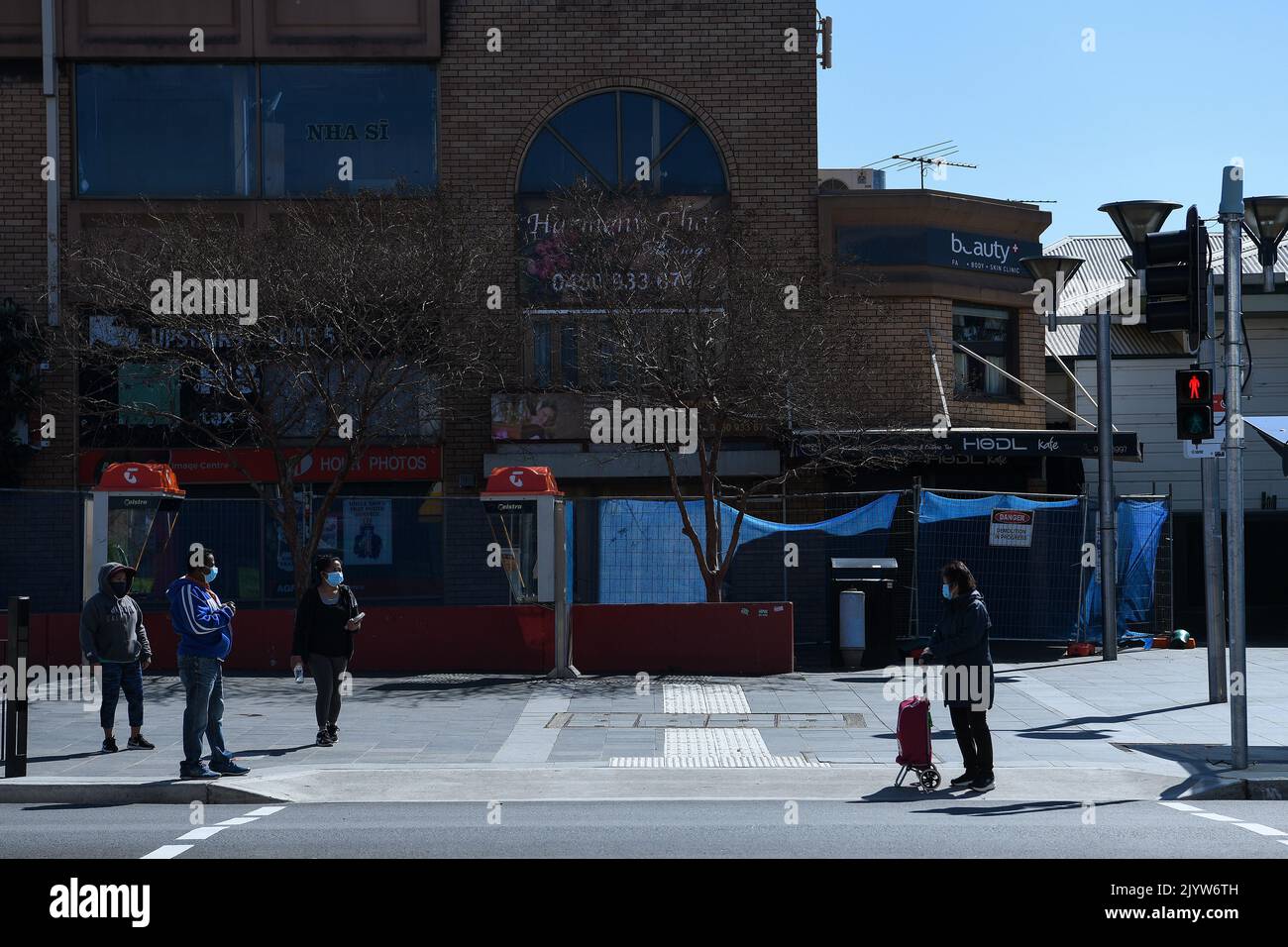 Members of the public wear face masks as they go about their daily ...