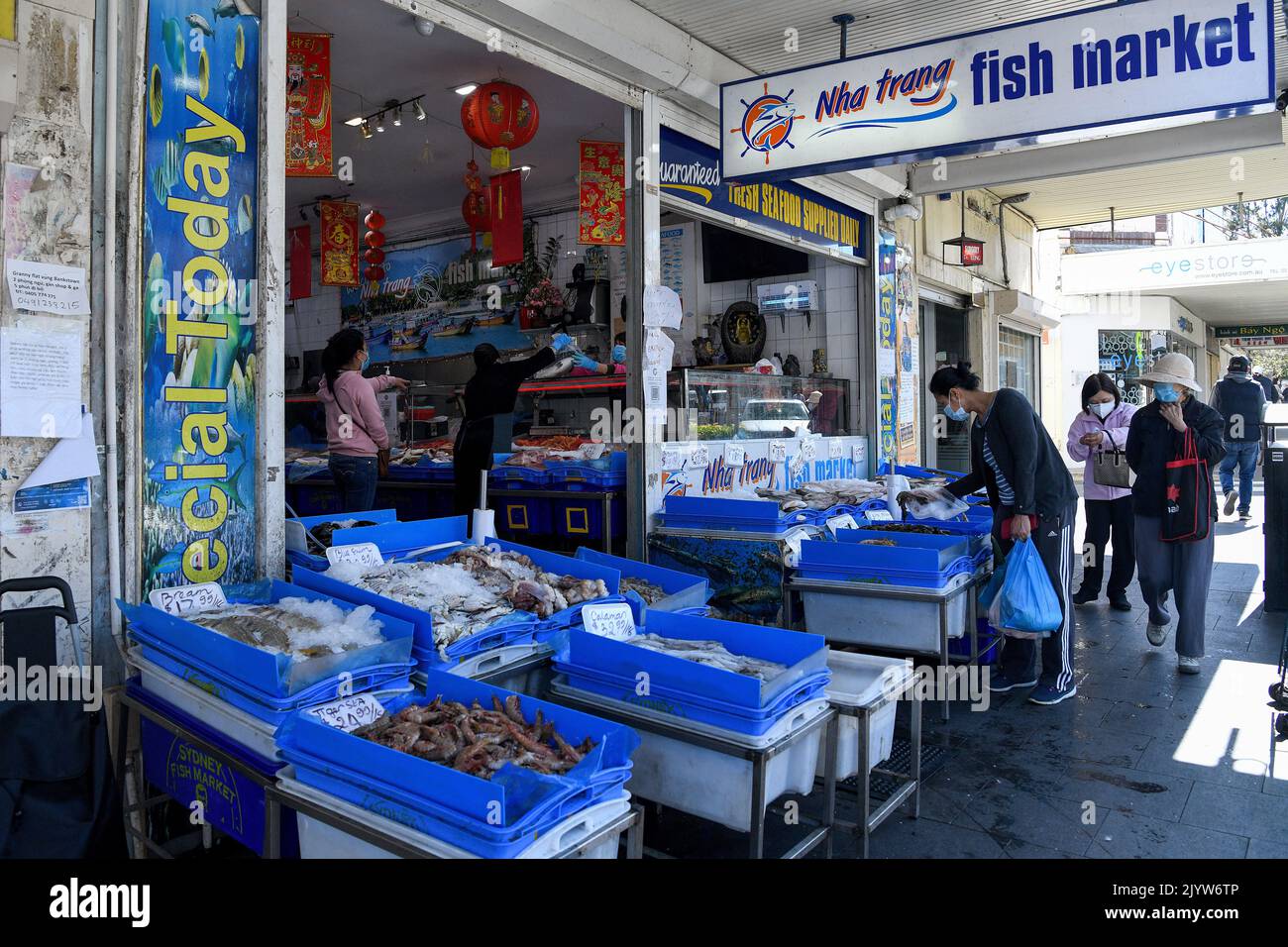 Members of the public wear face masks as they go about their daily ...