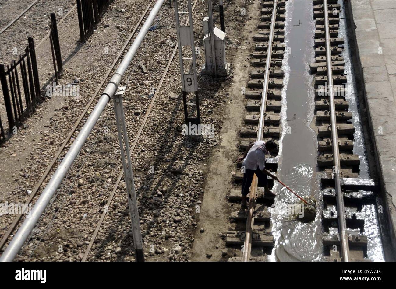 Labor is busy in cleaning the garbage and sewerage water from railway ...