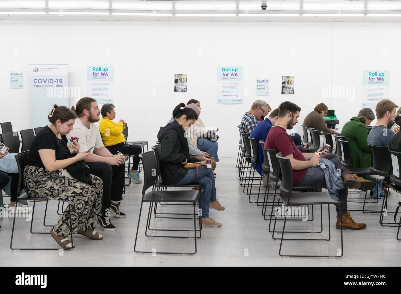 Members of the public wait in a recovery area after receiving a Pfizer ...