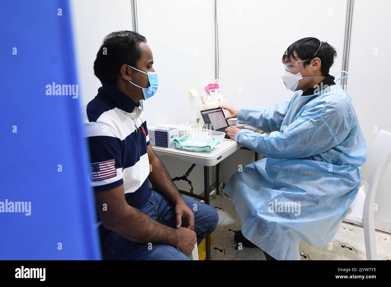 Rayees Mohammed (left) speaks with healthcare worker Chee Kin Lee prior ...