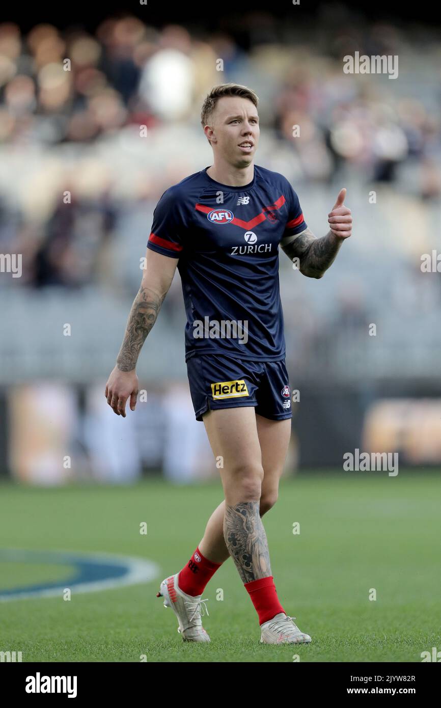 James Harmes of the Demons is seen warming up before the AFL ...