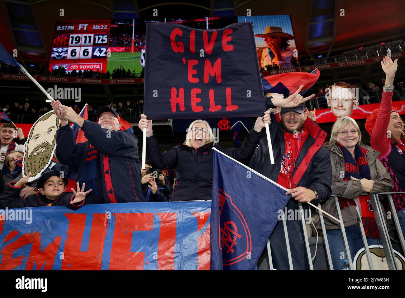 Demons fans celebrate after winning the AFL Preliminary Final match ...