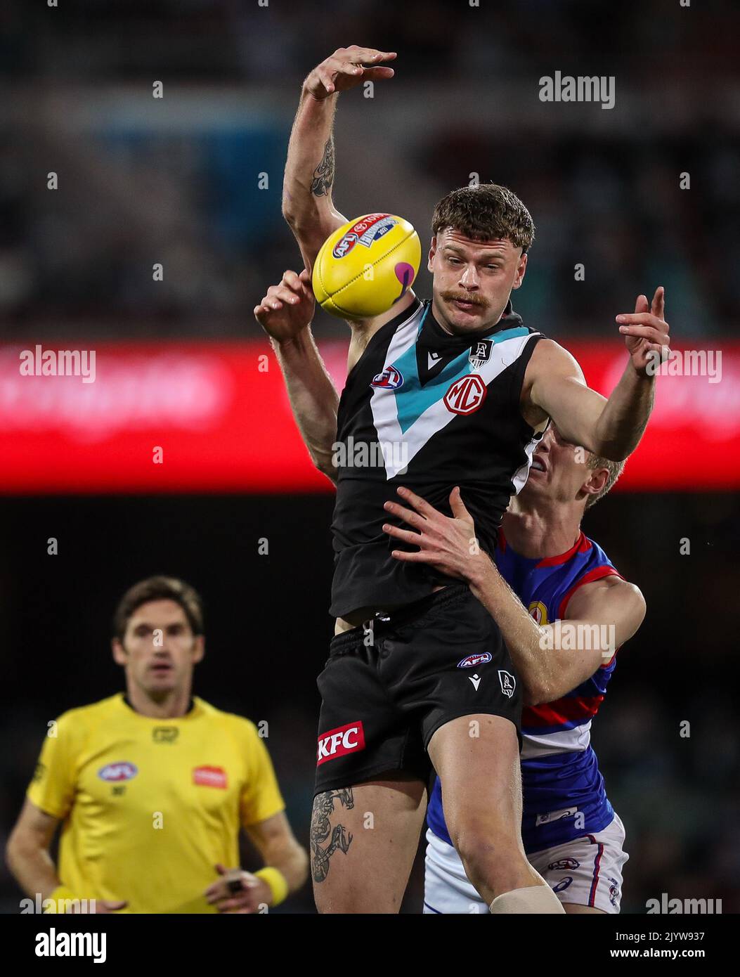 Peter Ladhams of the Power and Tim English of the Bulldogs compete in a ...