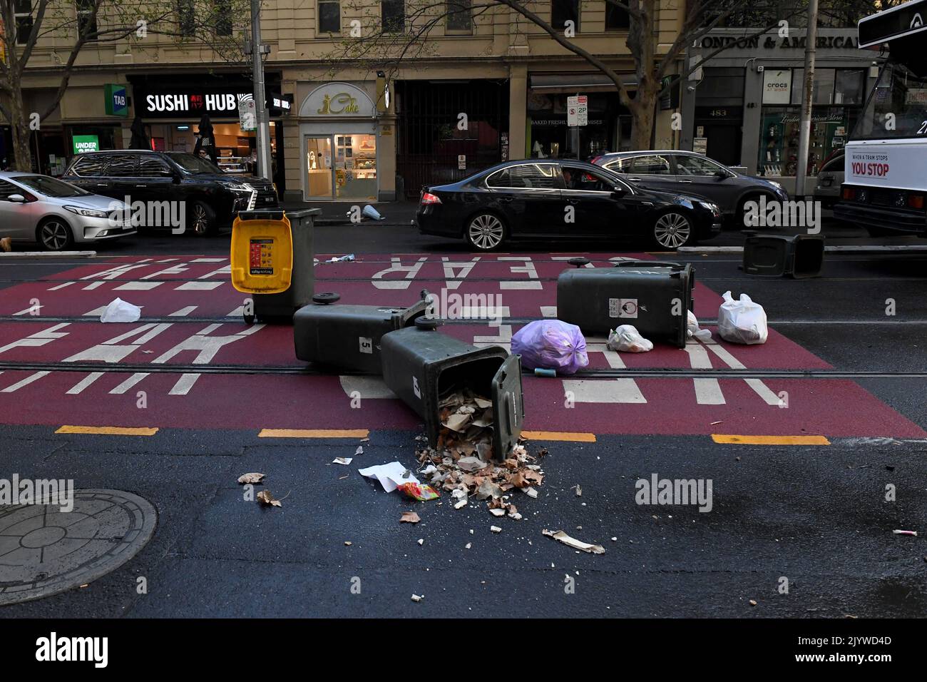 A construction worker throws garbage bins at a tram at a protest at ...