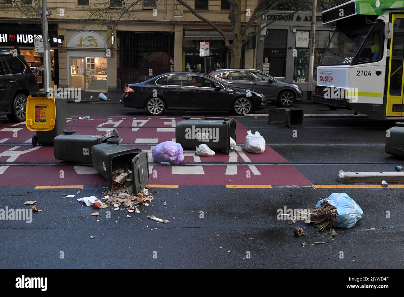 A construction worker throws garbage bins at a tram at a protest at ...