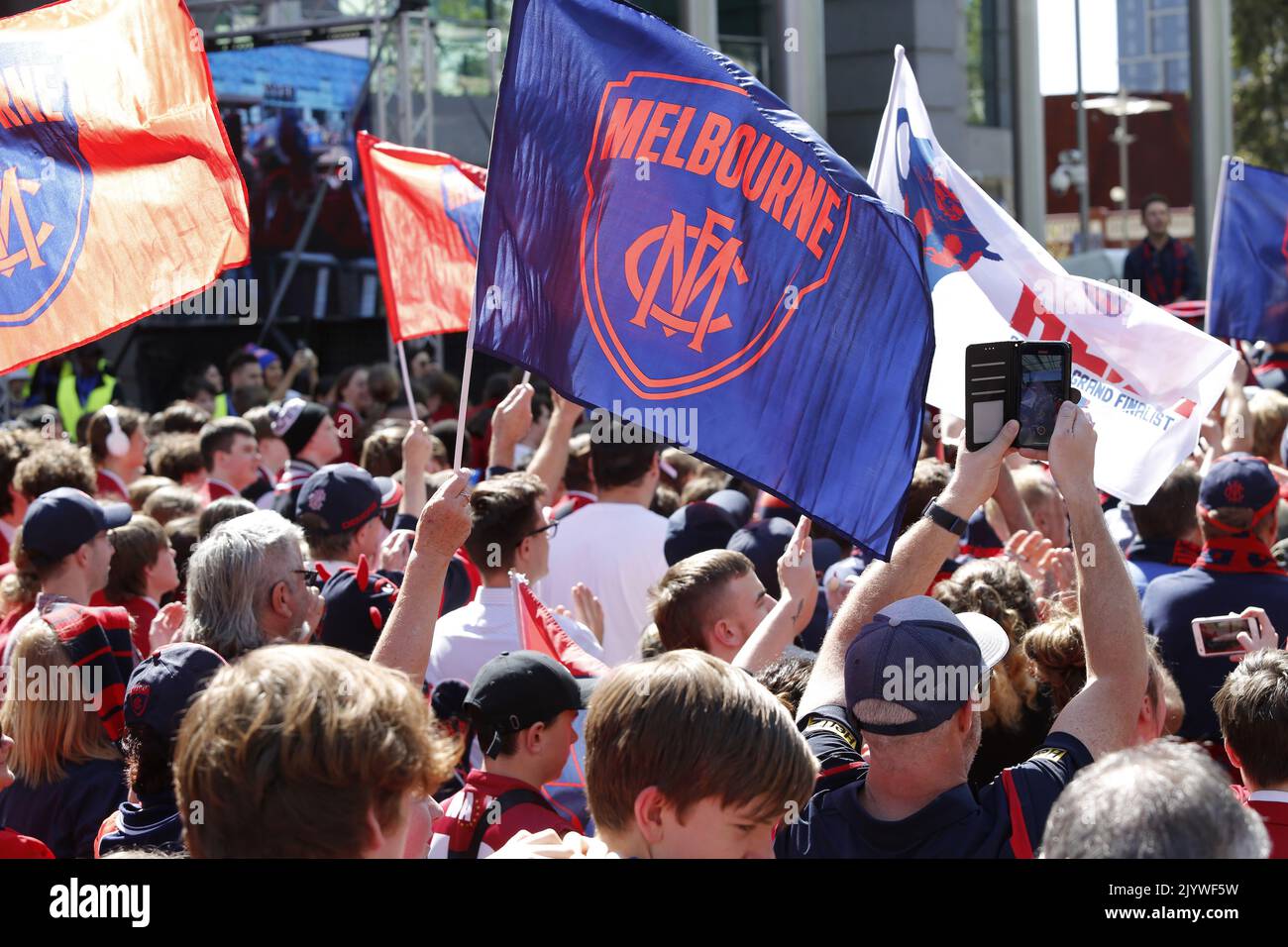 AFL fans wave flags during the People's Parade at Footy Place in Perth ...