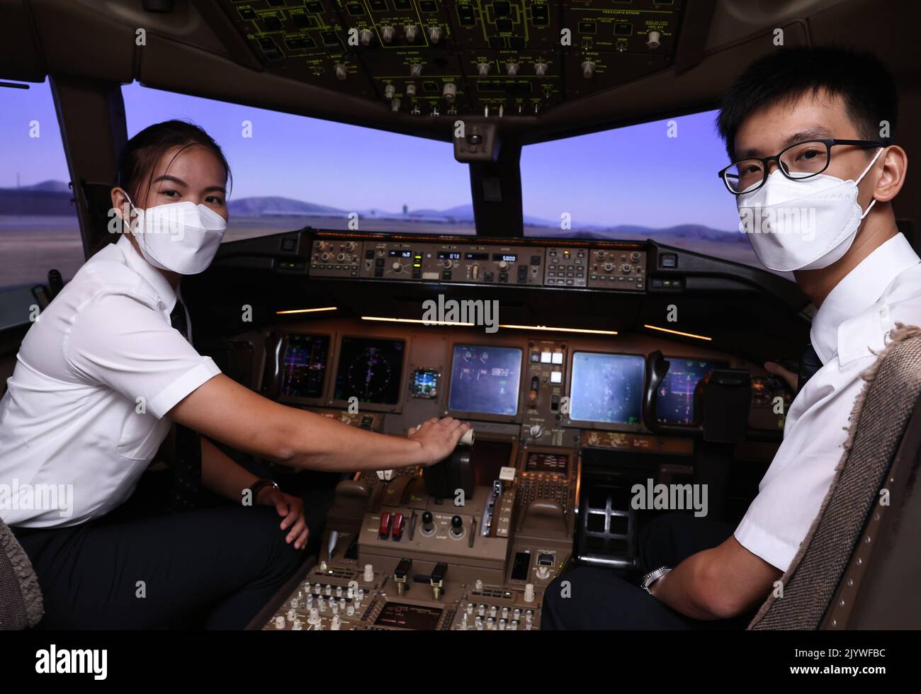 Cadet Pilot Cathy Chan (left) and Vincent Tsoi pose in the Boeing 777 ...
