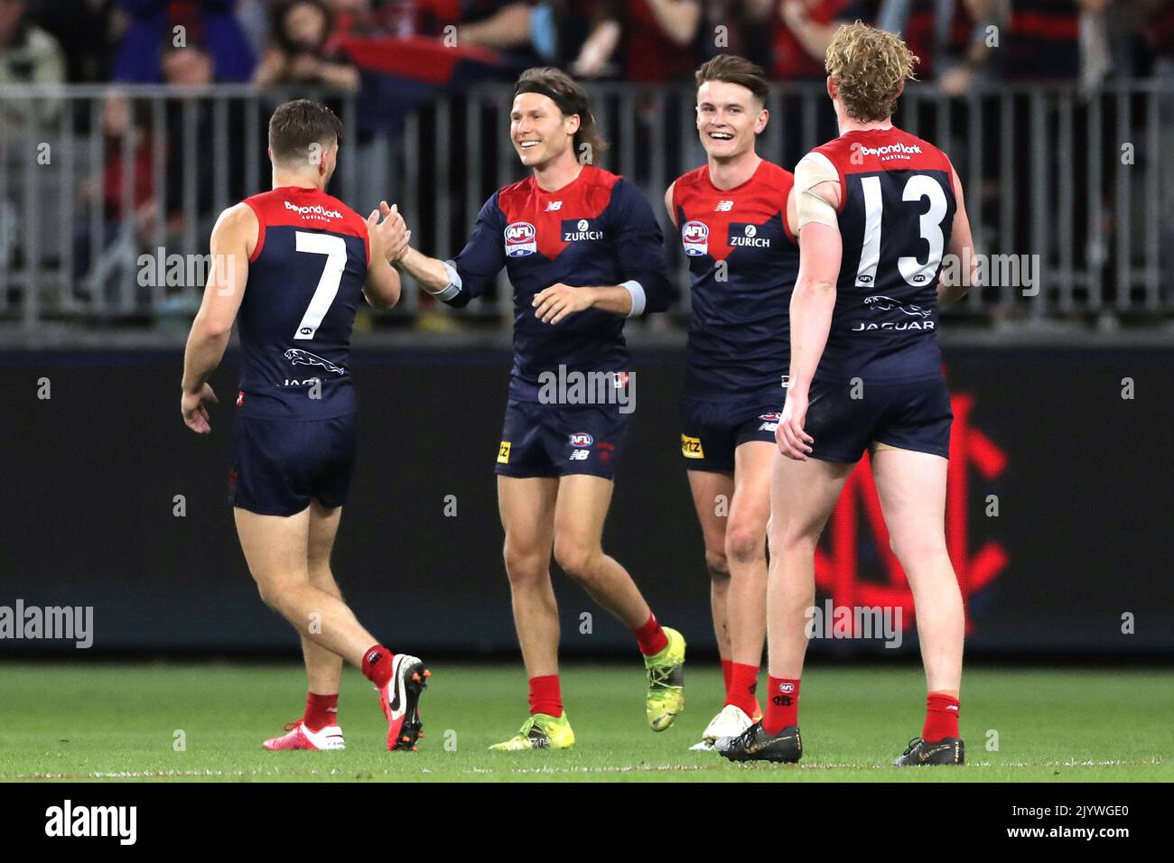 Ed Langdon of the Demons is congratulated by teammates after kicking a ...