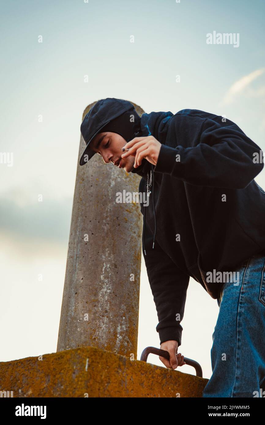 Guy with balaclava smoking a joint of marijuana Stock Photo - Alamy
