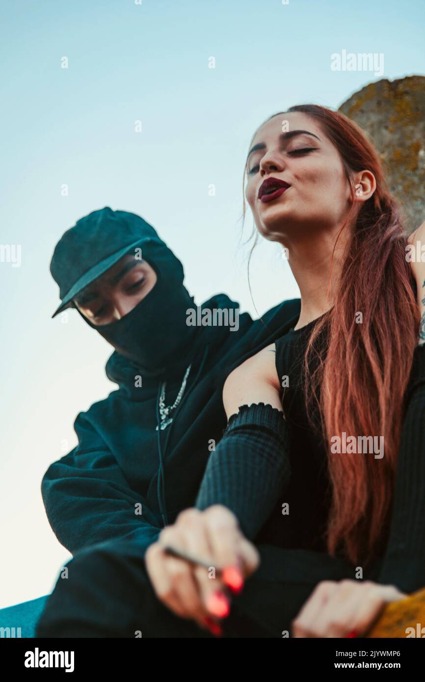 Young couple in love smoking a marijuana joint together Stock Photo - Alamy