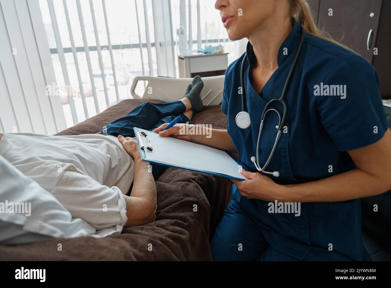 Professional doctor in uniform examines the patient during a visit to ...