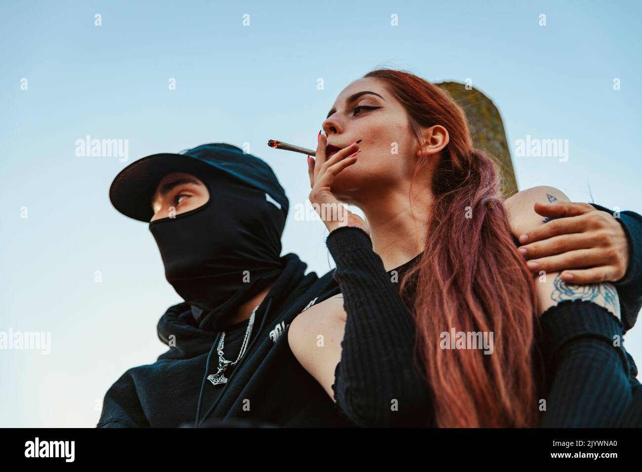 Young couple in love smoking a marijuana joint together Stock Photo - Alamy