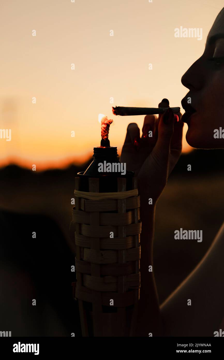 Young couple in love smoking a marijuana joint together Stock Photo - Alamy