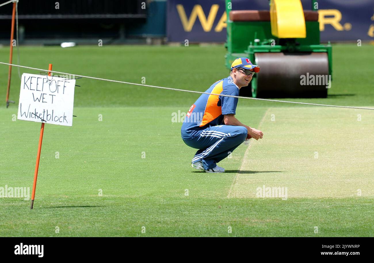 Australian cricketer Michael Clarke inspects the Gabba wicket prior to ...