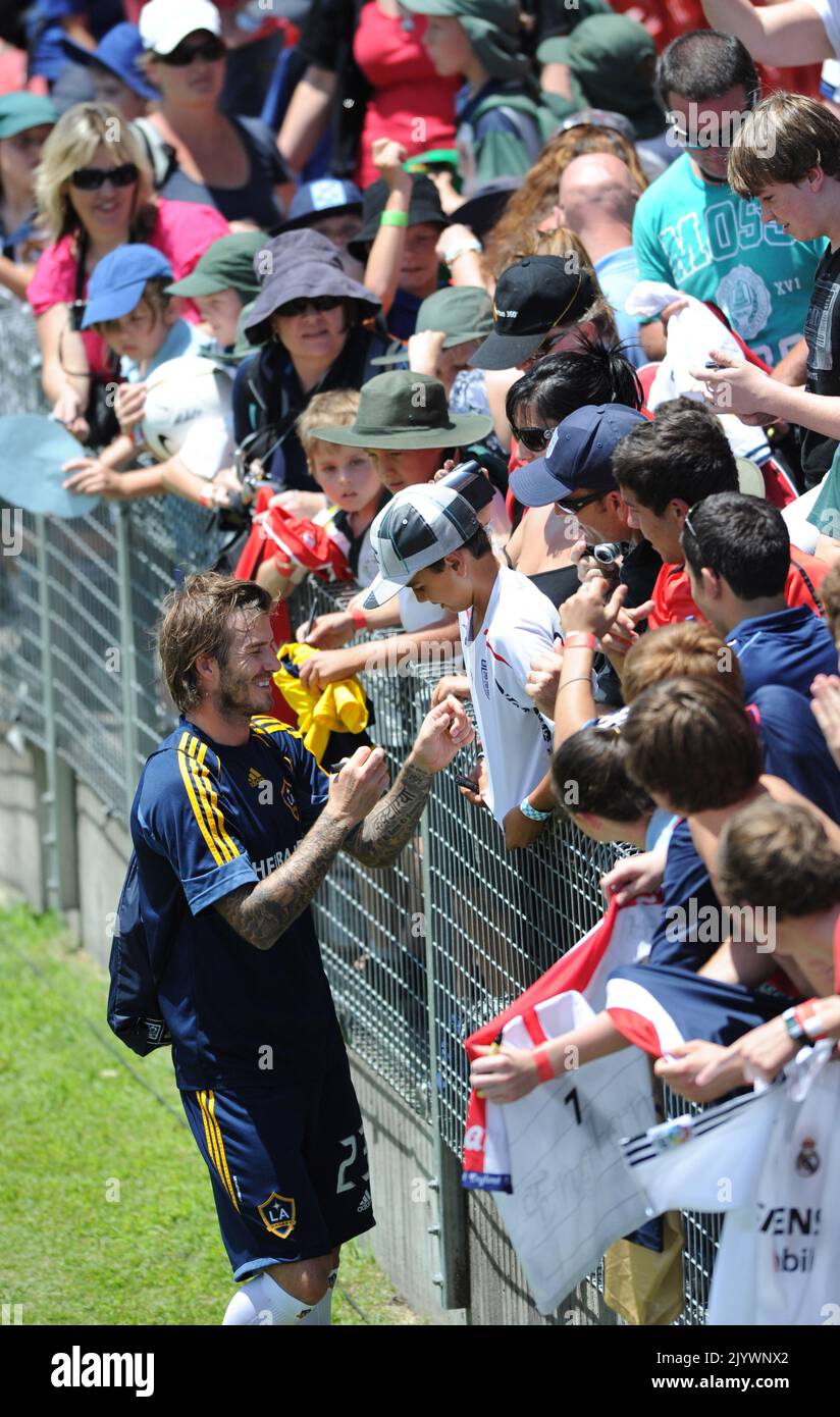 David Beckham signs autographs for fans during a training session with ...